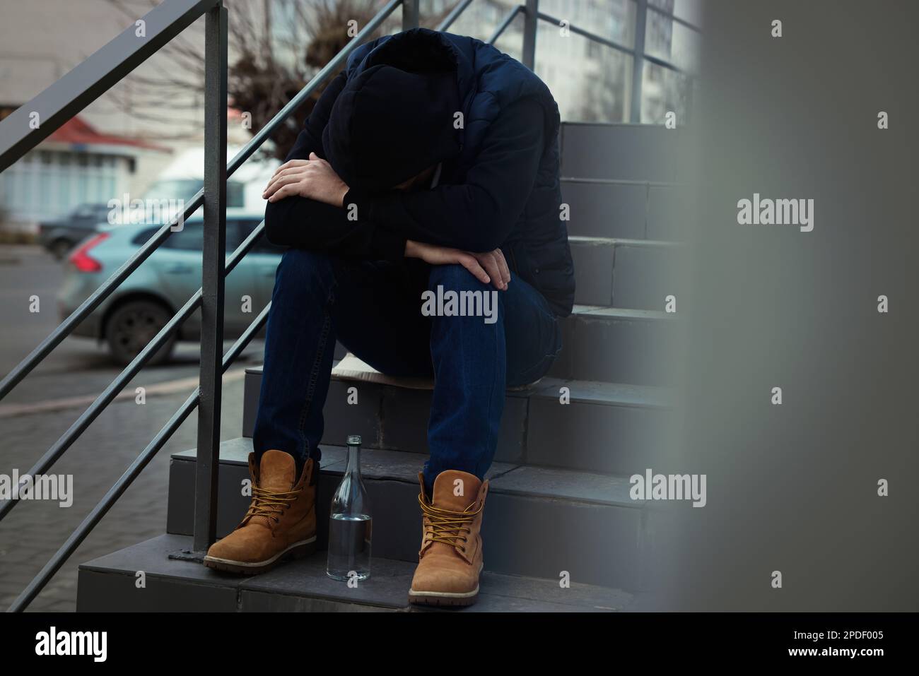 Addicted drunk man with alcoholic drink on stairs outdoors Stock Photo ...