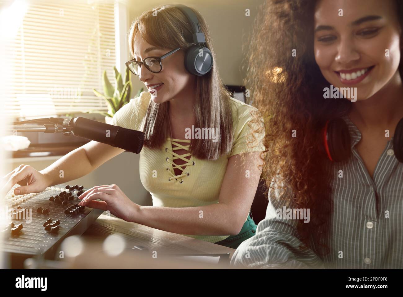Young women working in modern radio studio with professional equipment ...
