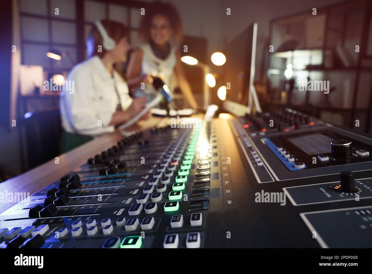 Women working in modern radio studio, focus on professional mixing ...