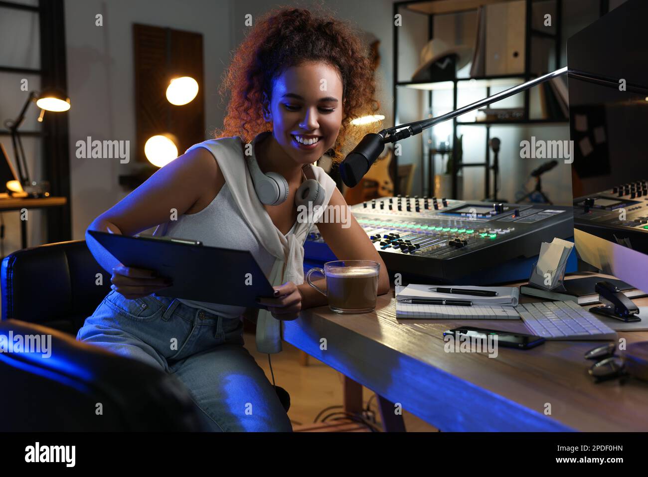African American woman working as radio host in modern studio Stock ...