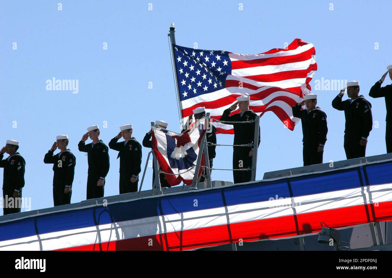 Sailors salute after the Navy's traditional "Man the Ship and Bring Her ...