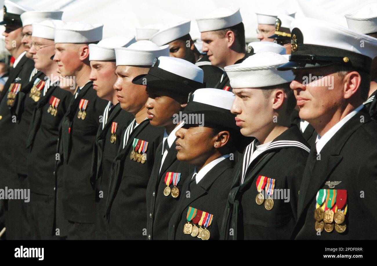 Some of the 360 crew members of the USS San Antonio stand during ...