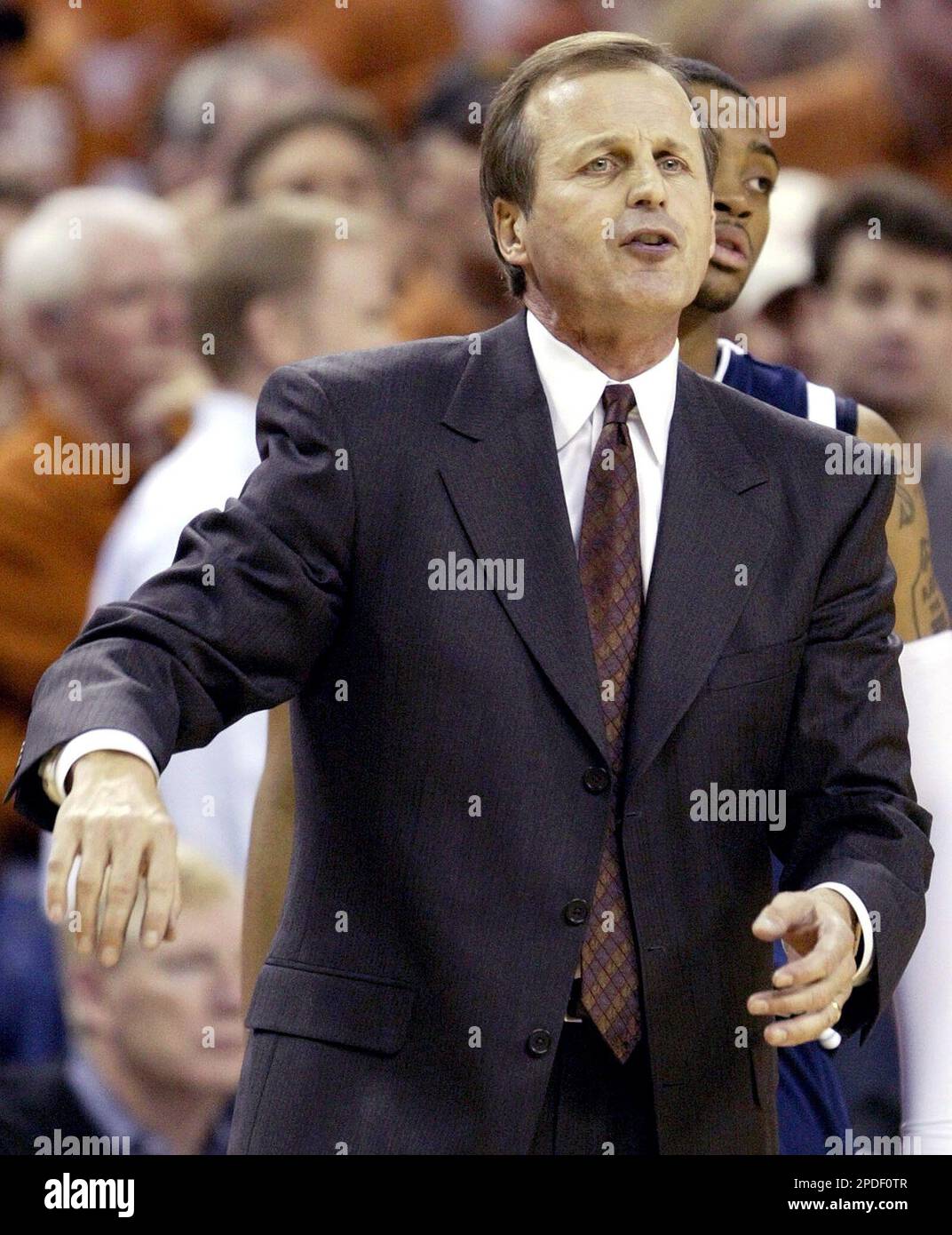 Texas head basketball coach Rick Barnes, foreground, shouts ...