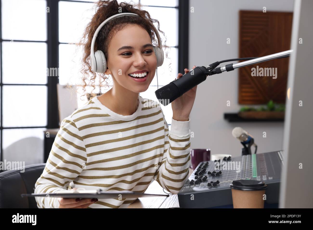 African American woman working as radio host in modern studio Stock ...