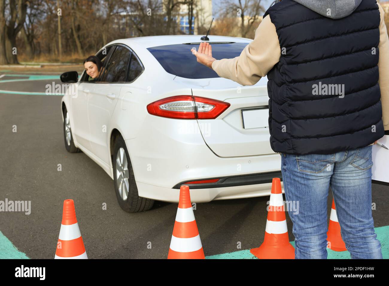 Instructor and student in car during exam on test track. Driving school ...