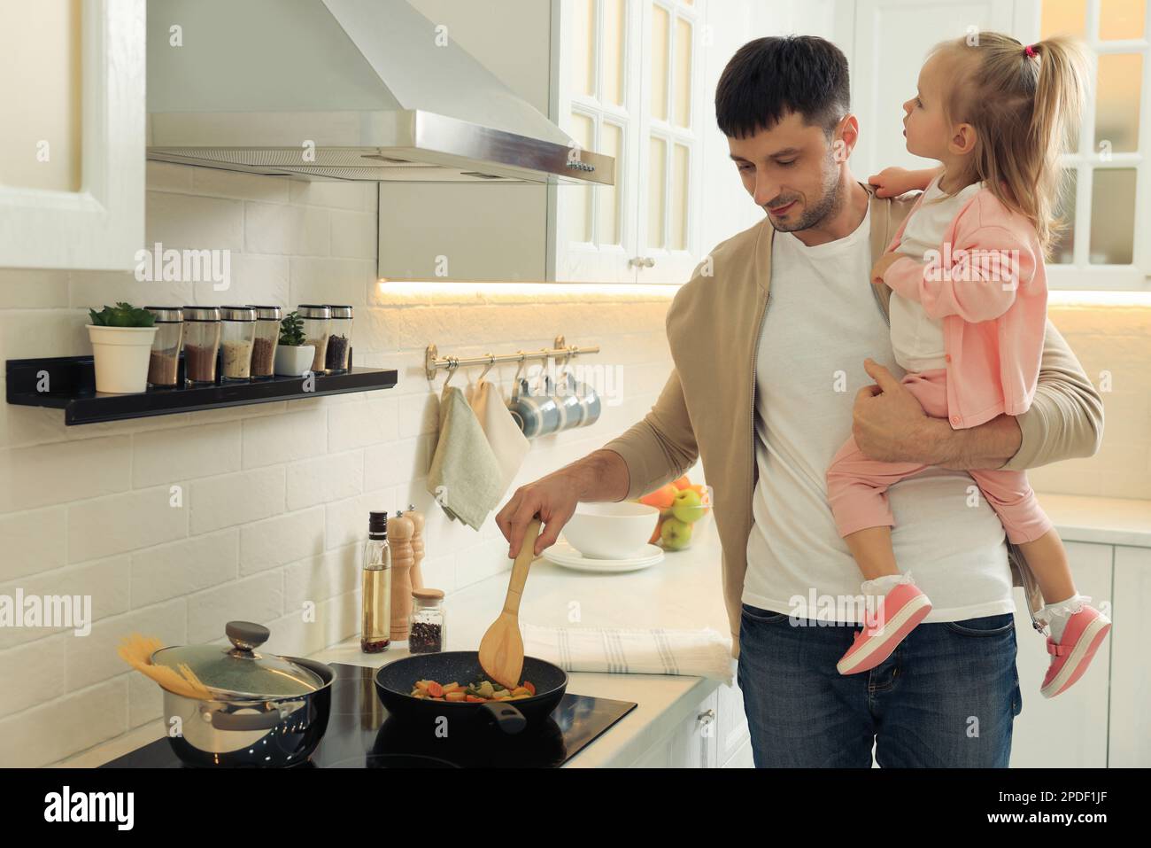 Father and daughter cooking together in kitchen Stock Photo - Alamy