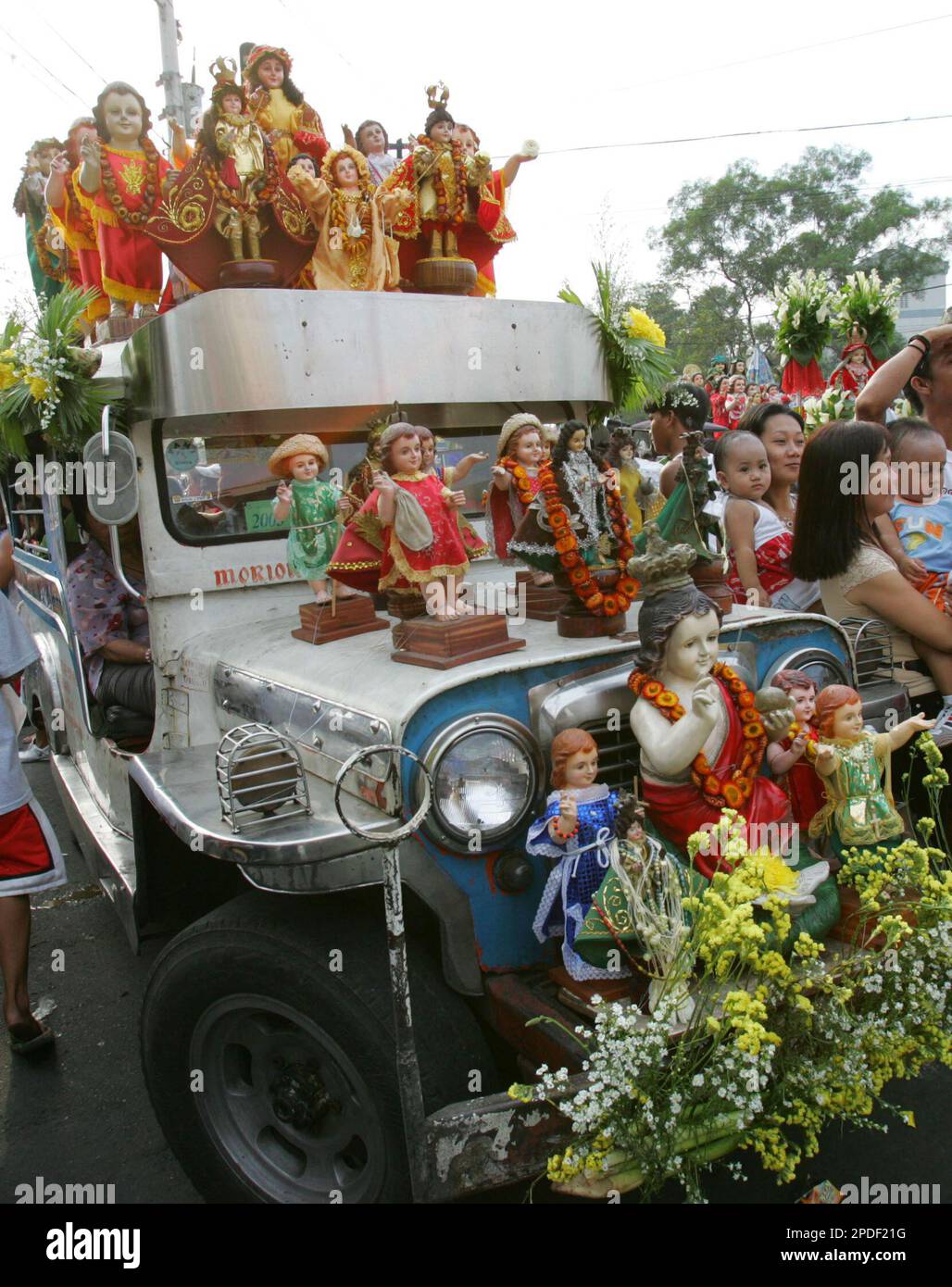 A commuter jeepney (modified jeep) is loaded with different images of ...