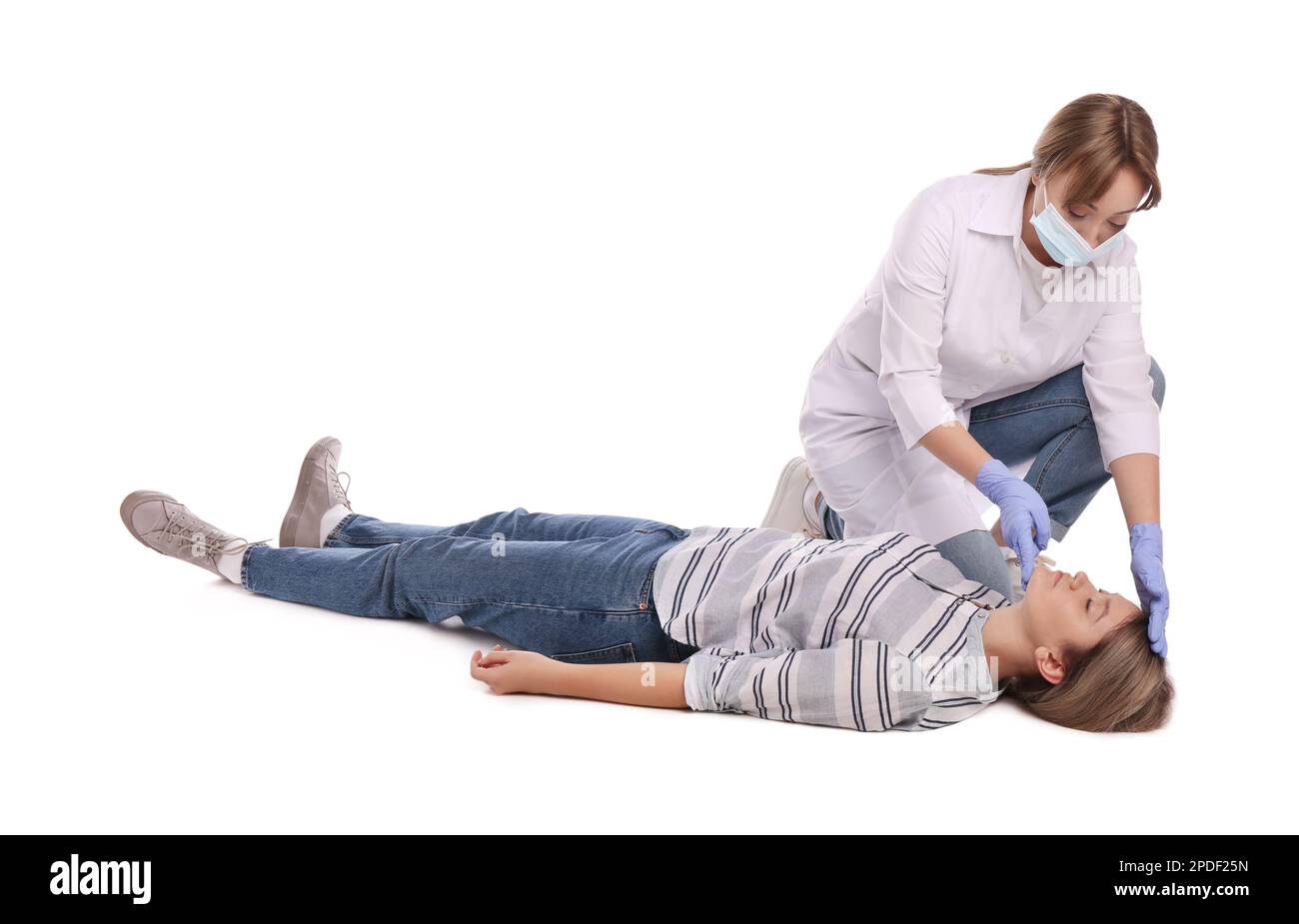 Doctor in uniform and protective mask performing first aid on ...