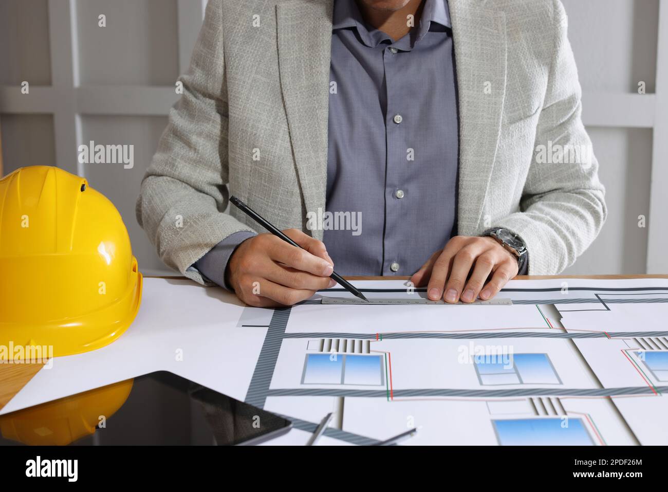 Architect working with construction drawings indoors, closeup Stock ...