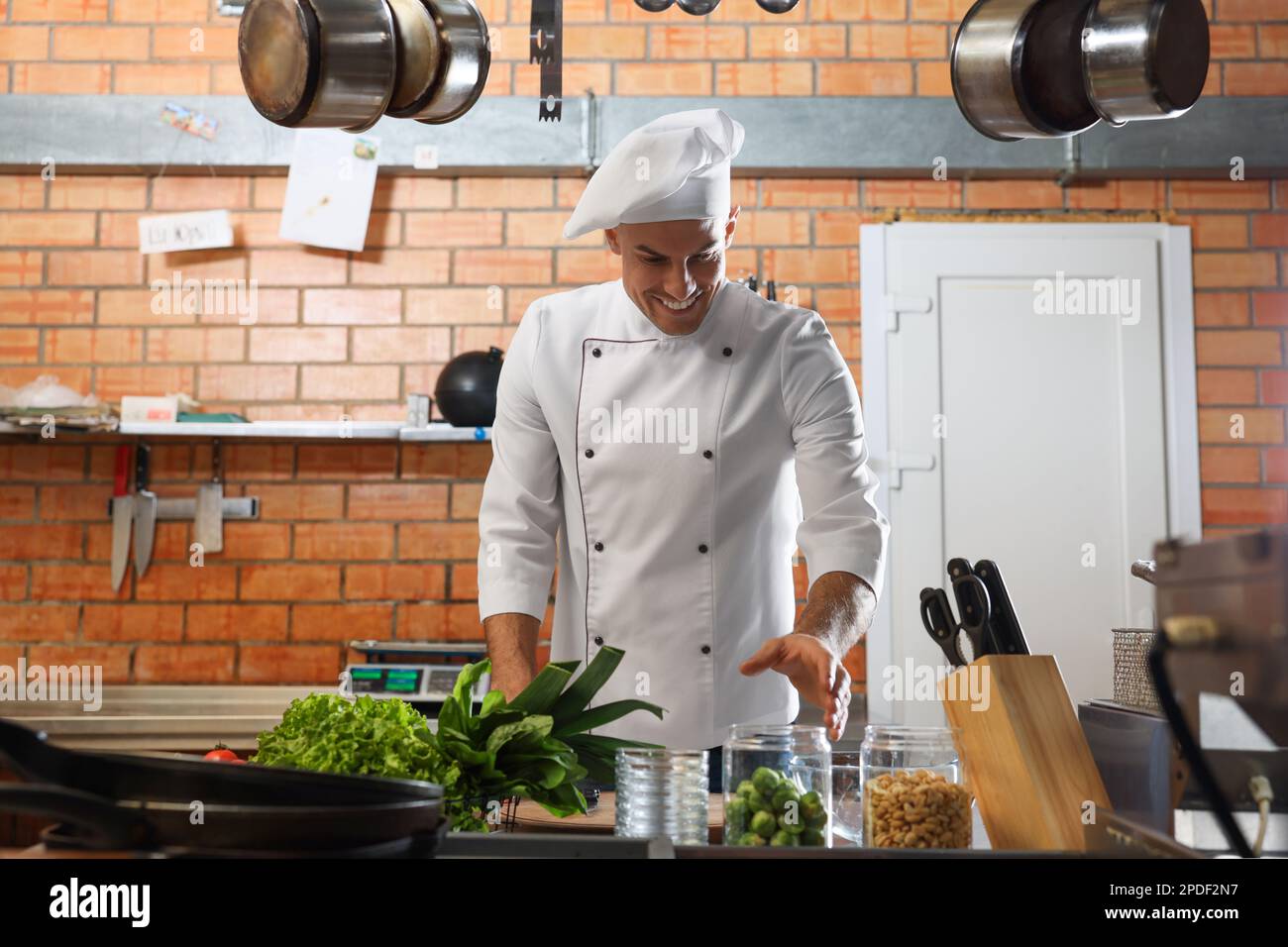 Professional chef cooking vegetables in restaurant kitchen Stock Photo ...