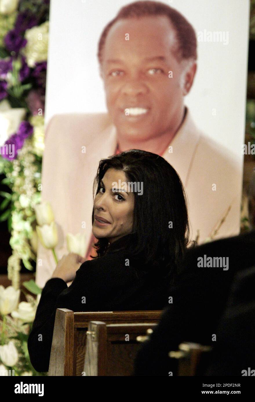 Nina Rawls, widow of singer Lou Rawls, looks to the rear of the church ...