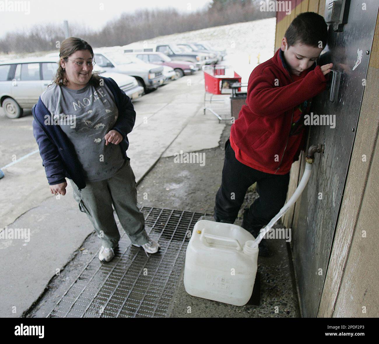 Zach Williams, 9, fills jugs of water at the Safeway supermarket in ...