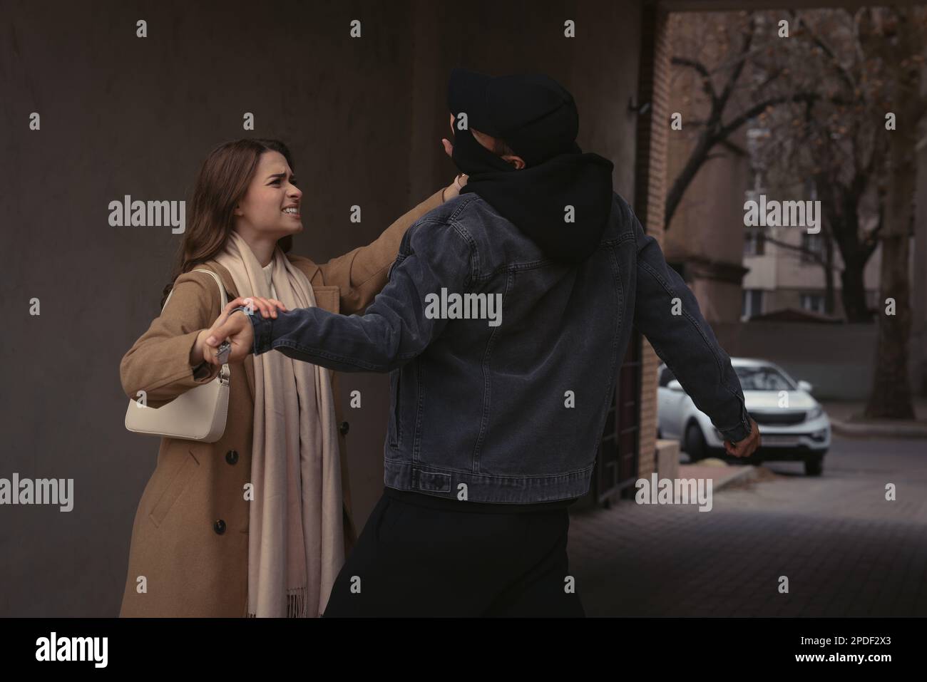 Woman defending herself from attacker with knife in alley Stock Photo ...
