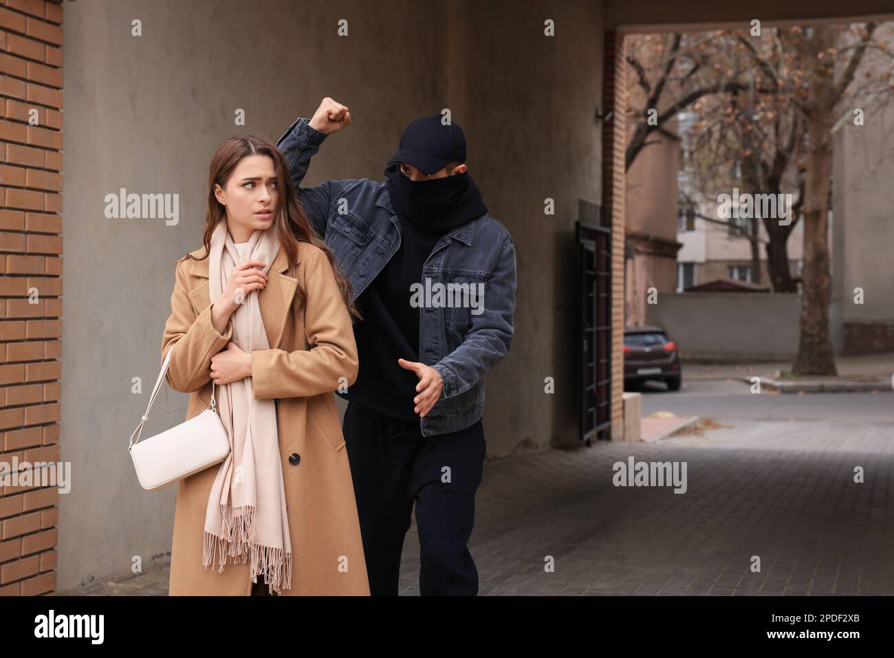 Criminal attacking young woman in alley, space for text. Self defense ...