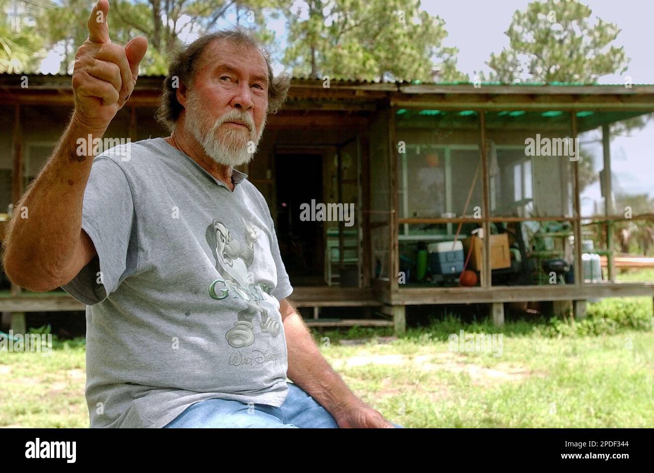 **FILE** Jesse Hardy gestures in front of his home in the middle of the ...