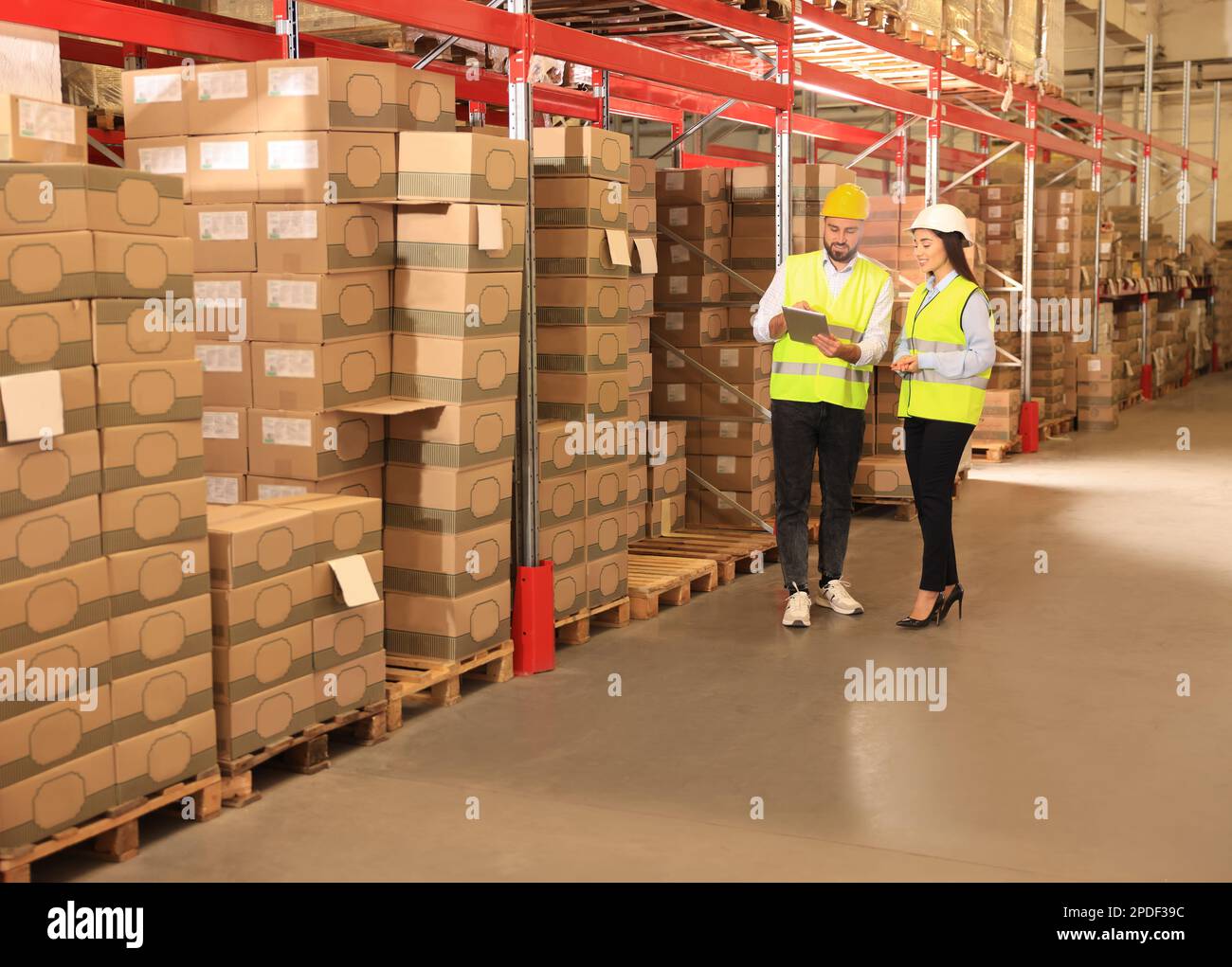 Manager and worker at warehouse. Logistics center Stock Photo - Alamy
