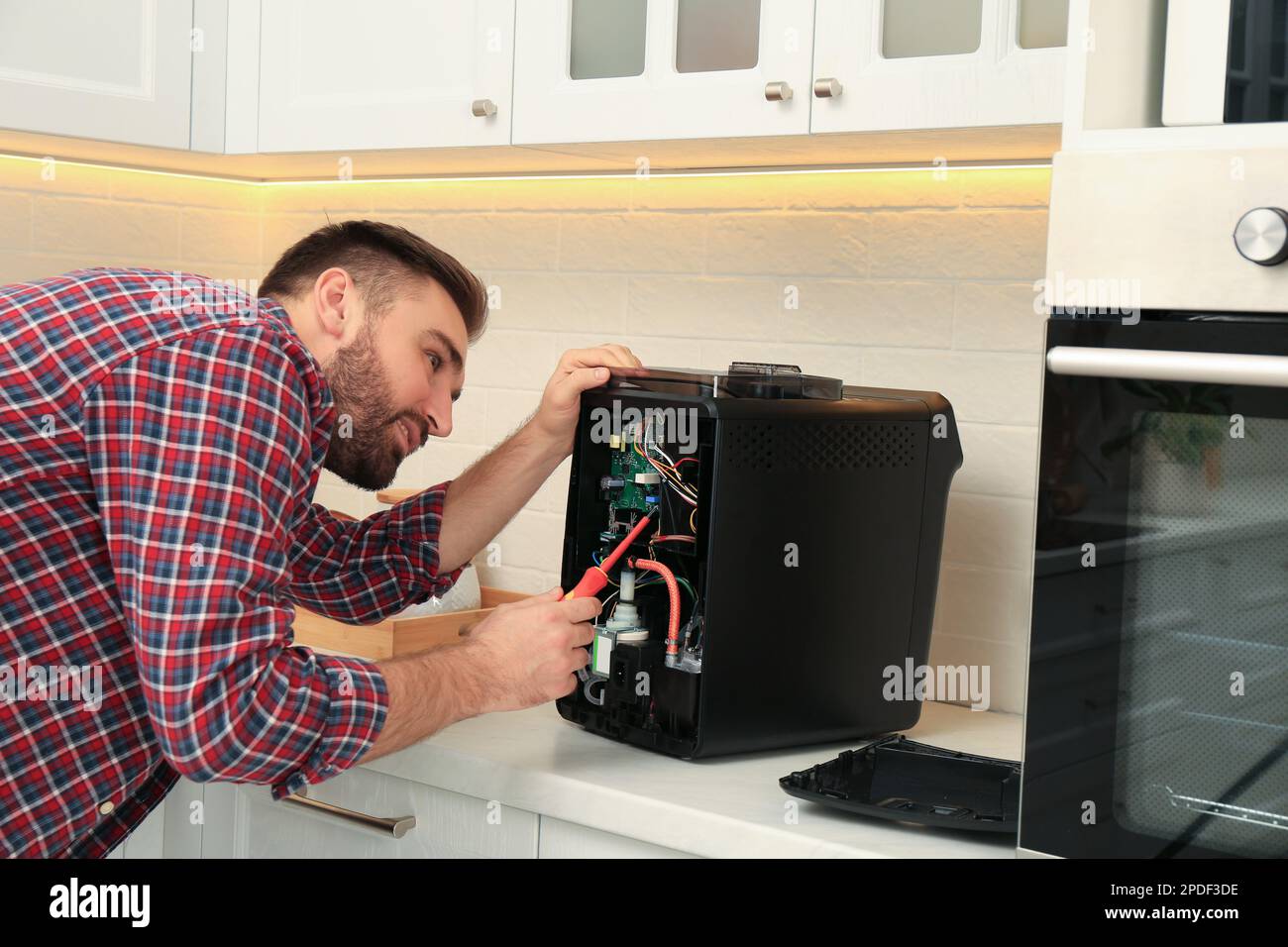 Man fixing coffee machine hi-res stock photography and images - Alamy