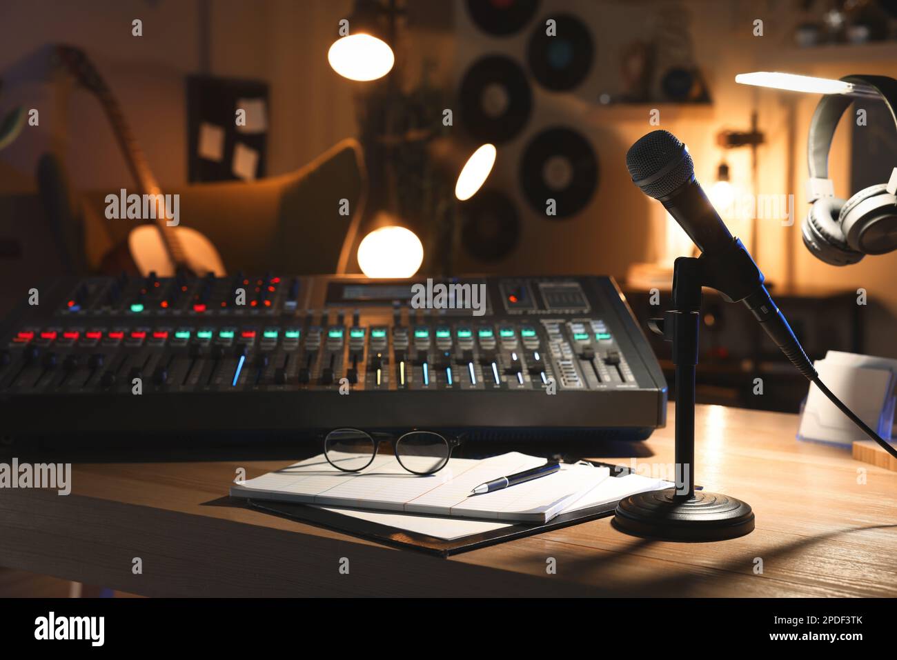 Microphone and professional mixing console on table in radio studio ...