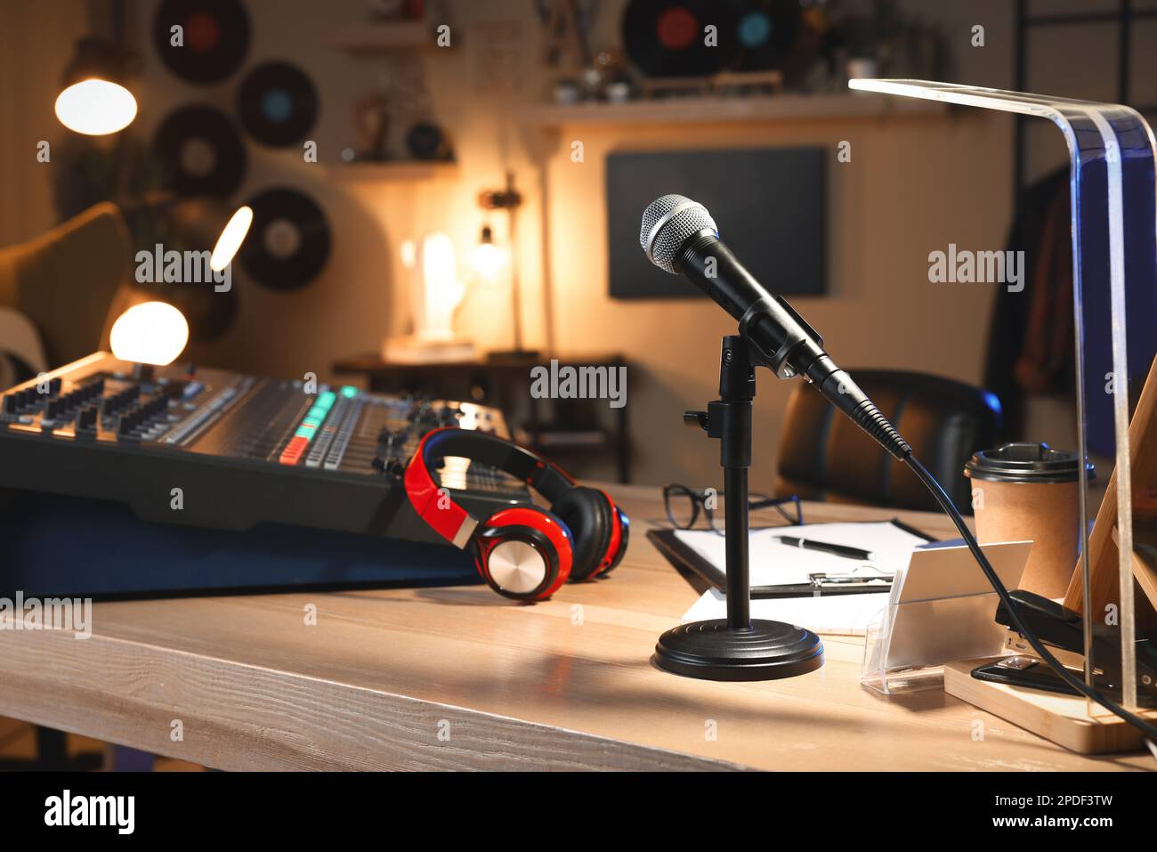 Microphone and professional mixing console on table in radio studio ...