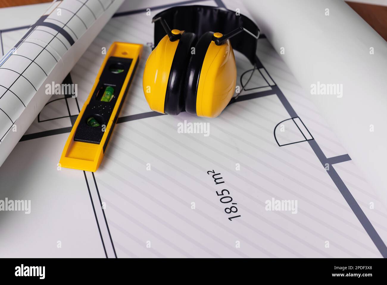 Construction drawings, safety headphones and ruler, closeup view Stock ...