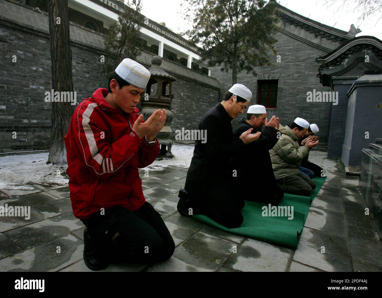 Chinese Muslim men offer Friday prayers at the Niu Jie mosque in ...