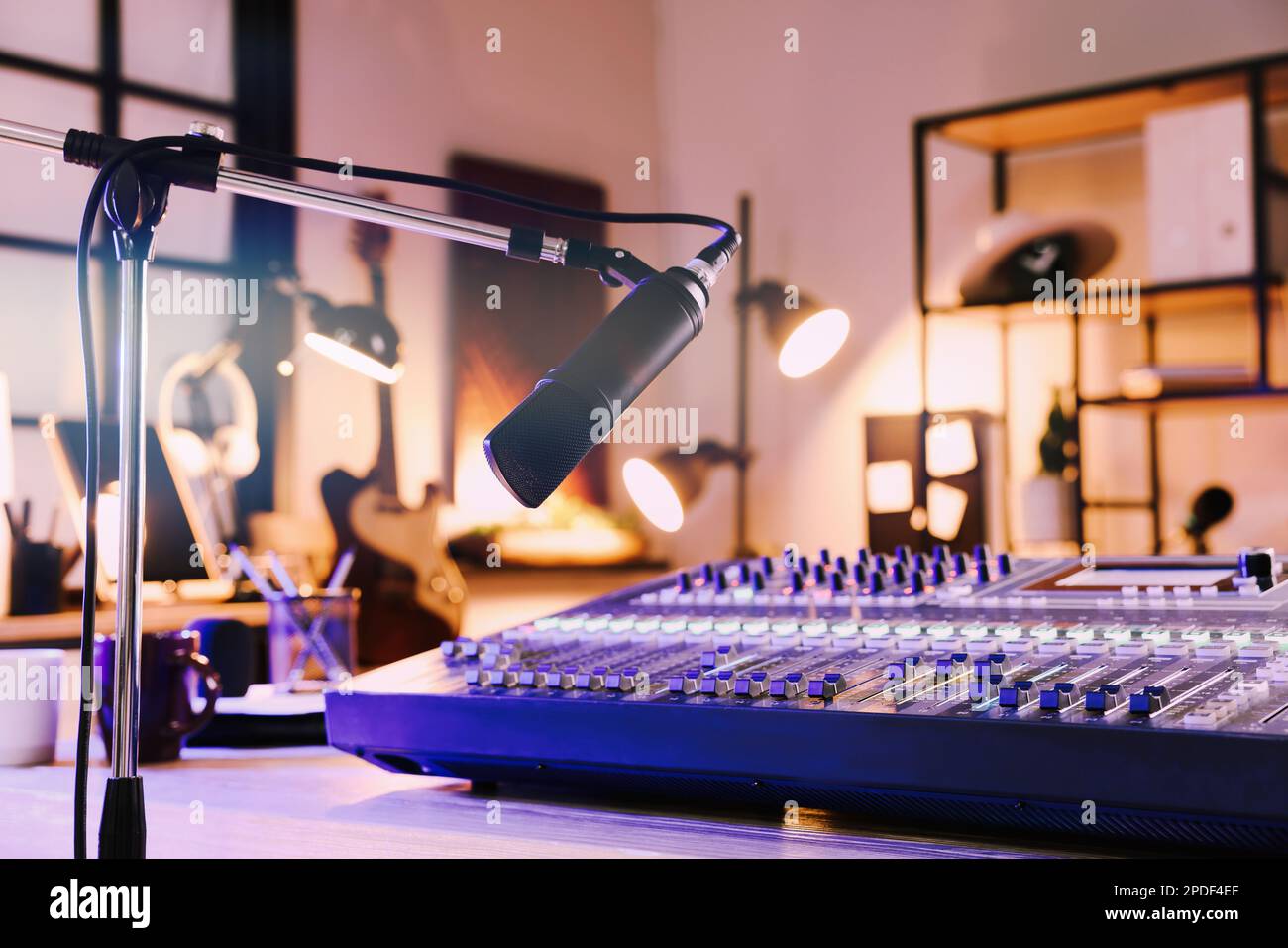Microphone near table with professional mixing console in radio studio ...
