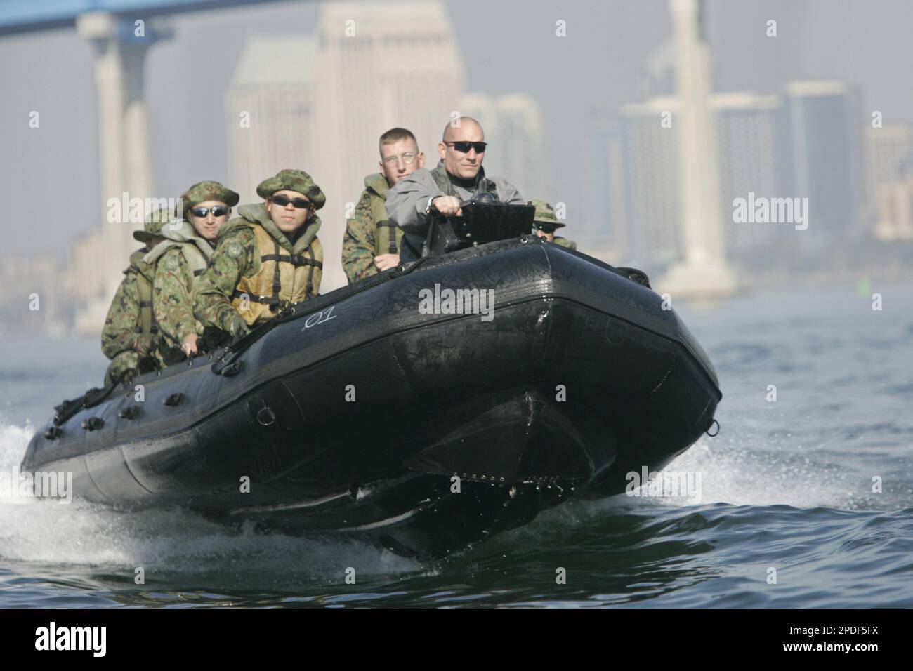 Members of the Japanese Ground Self Defense Force ride in a combat ...