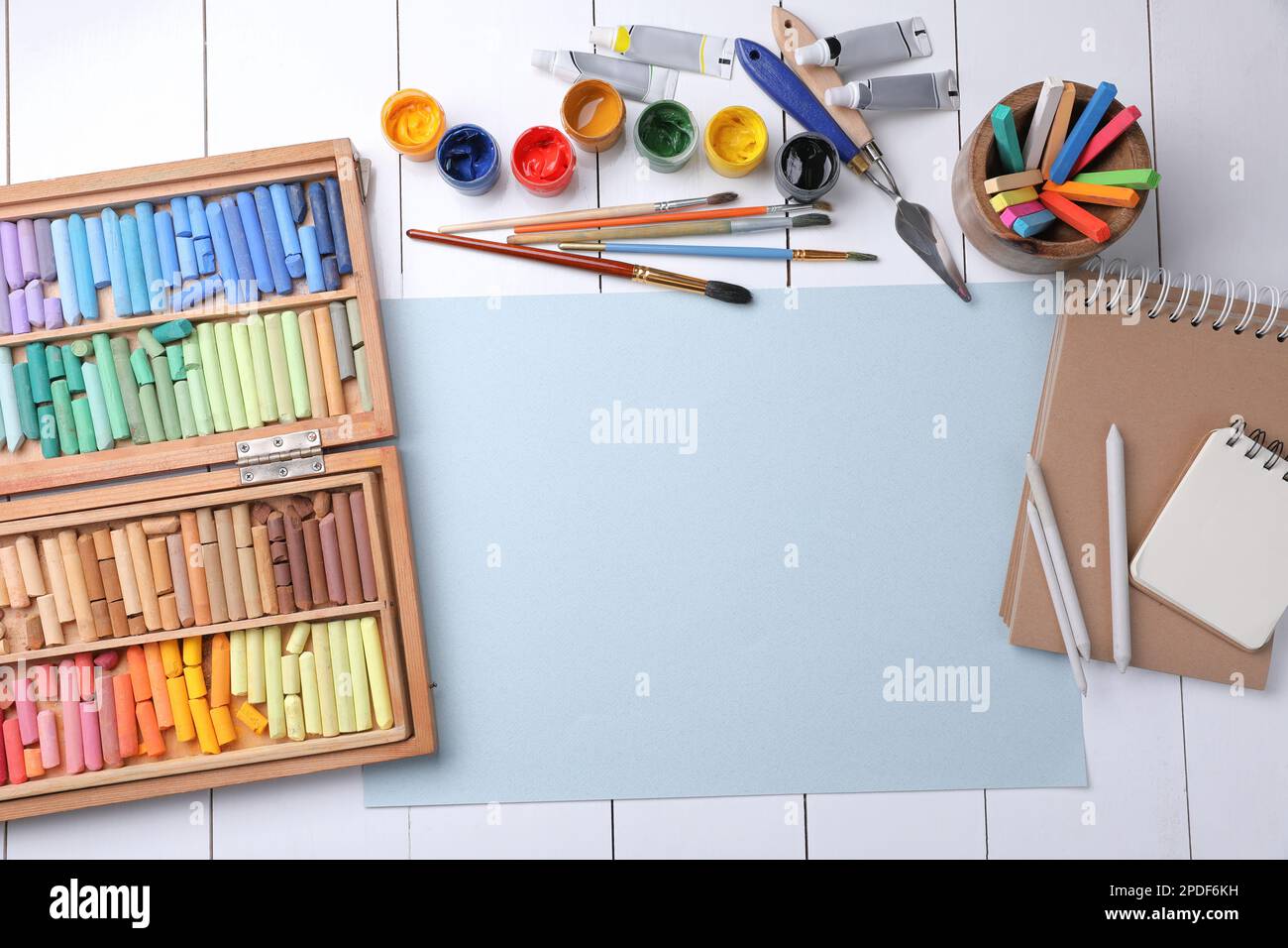 Blank sheet of paper, colorful chalk pastels and other drawing tools on ...