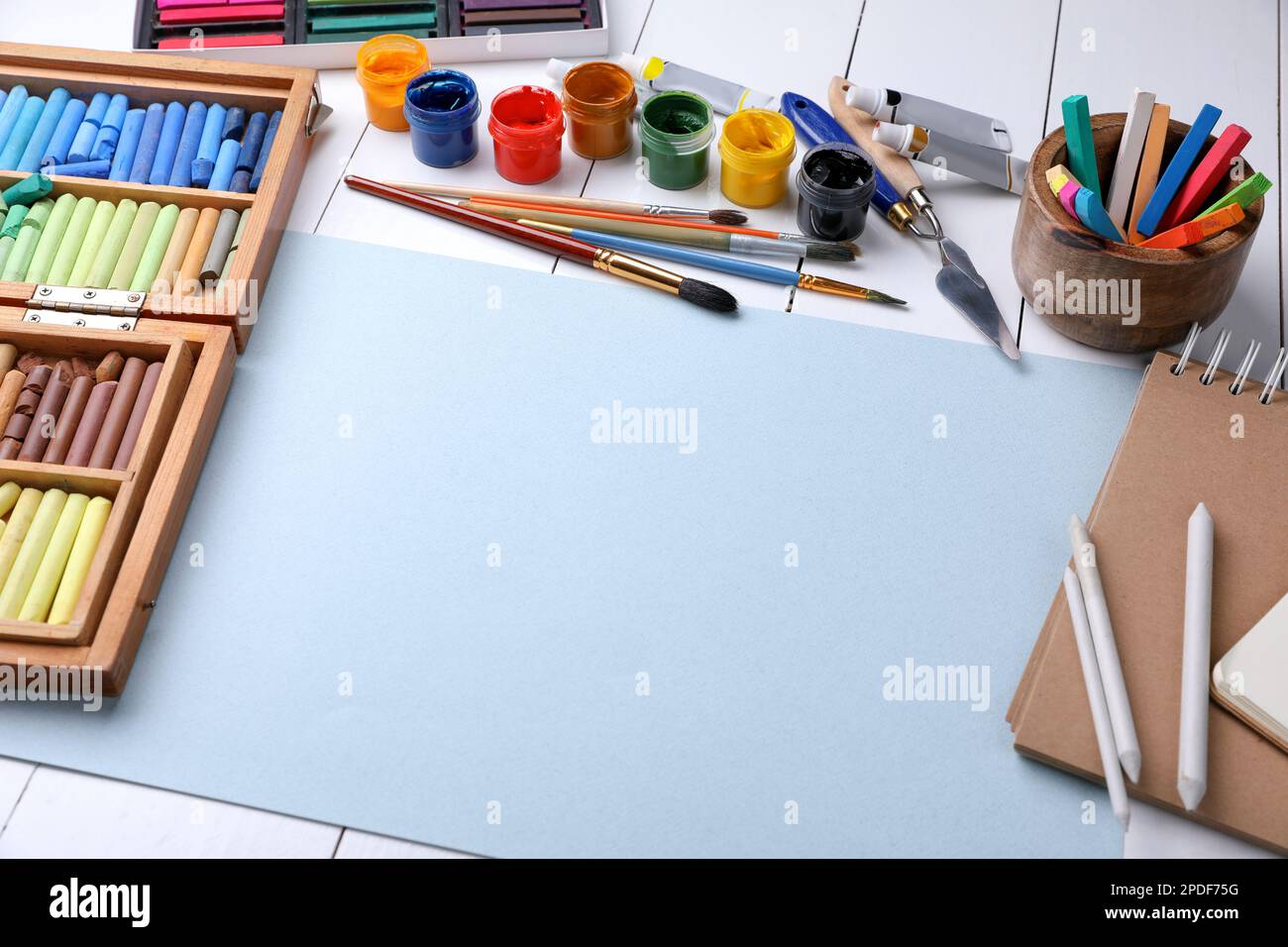 Blank sheet of paper, colorful chalk pastels and other drawing tools on ...