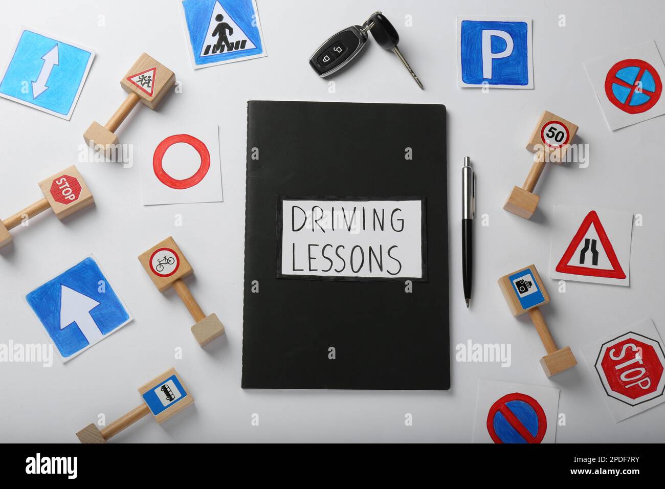 Composition with workbook for driving lessons on white background, top ...