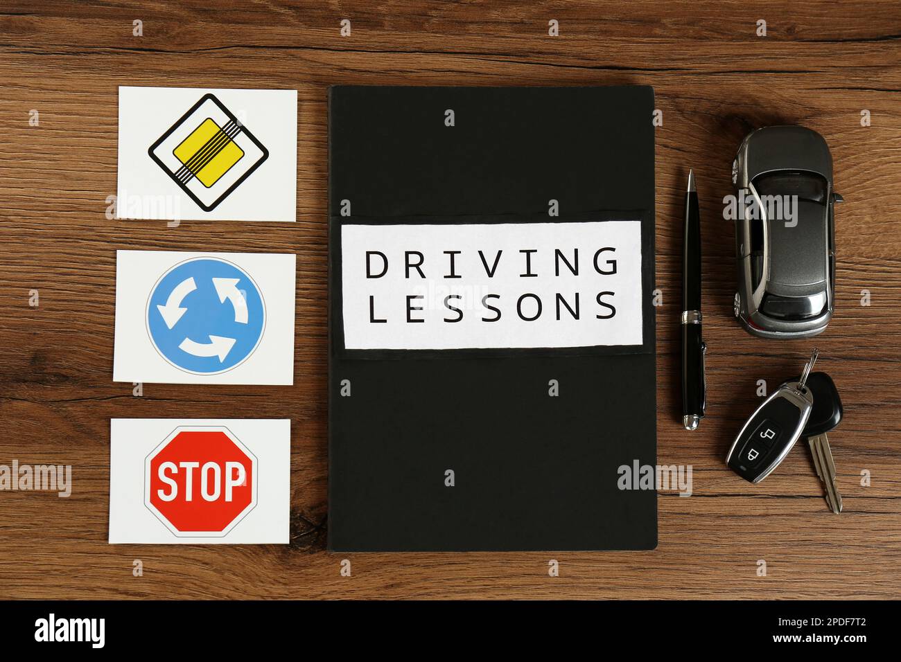 Flat lay composition with workbook for driving lessons and road signs ...