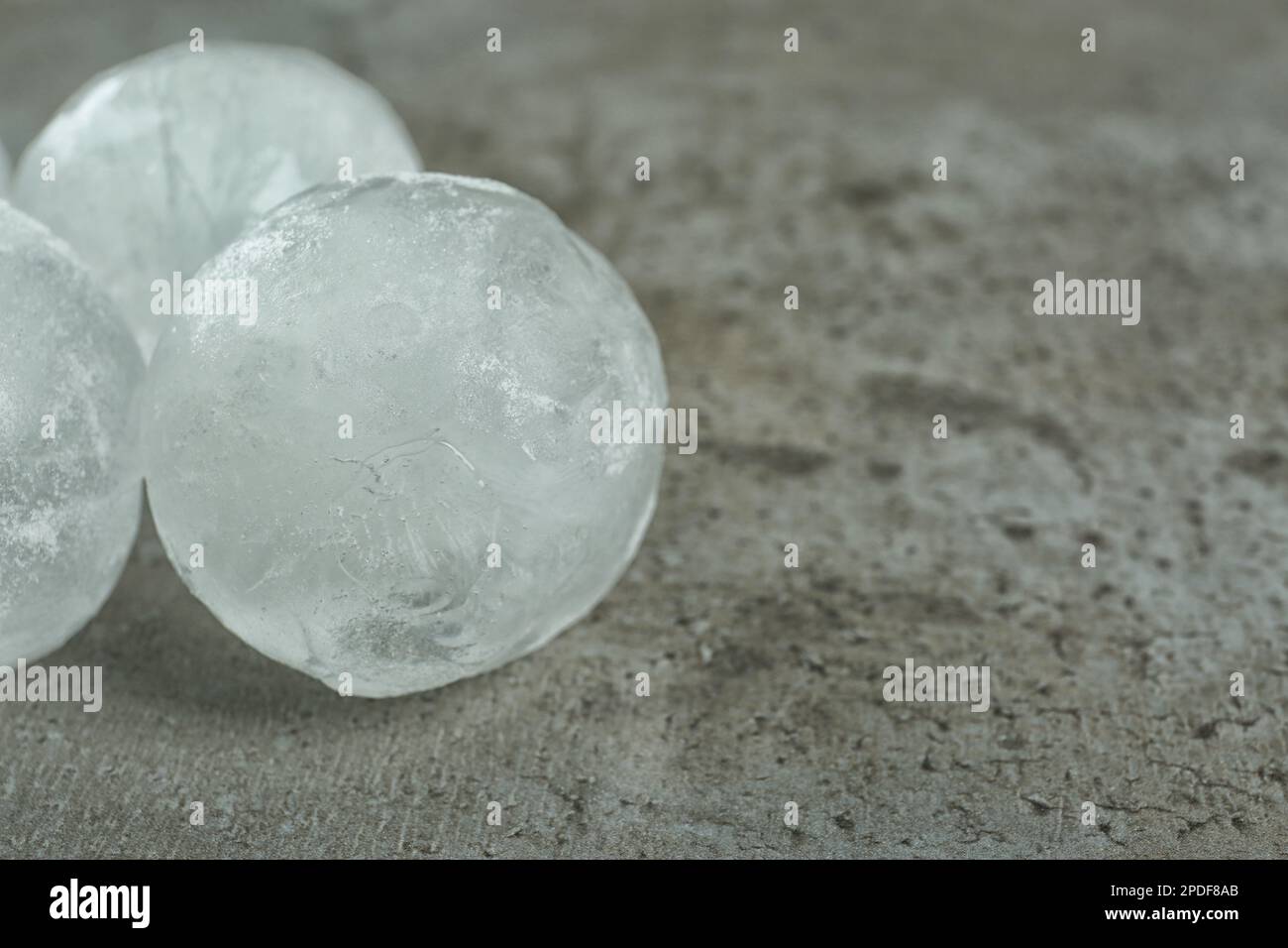 Frozen ice balls on grey table, closeup. Space for text Stock Photo - Alamy