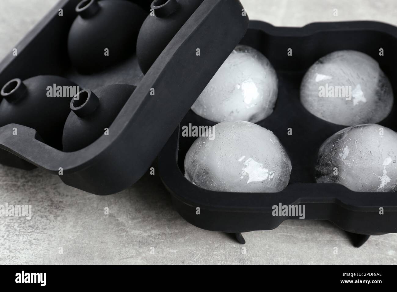 Frozen ice balls in mold on grey table, closeup Stock Photo - Alamy
