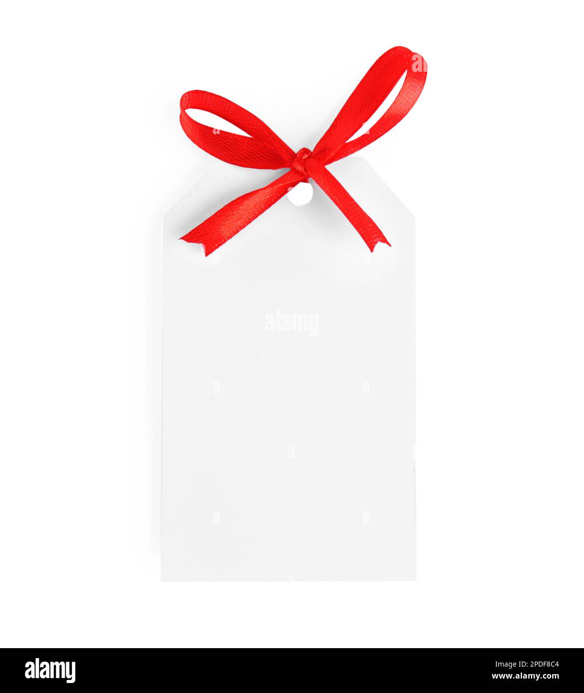 Blank gift tag with red satin ribbon on white background, top view ...