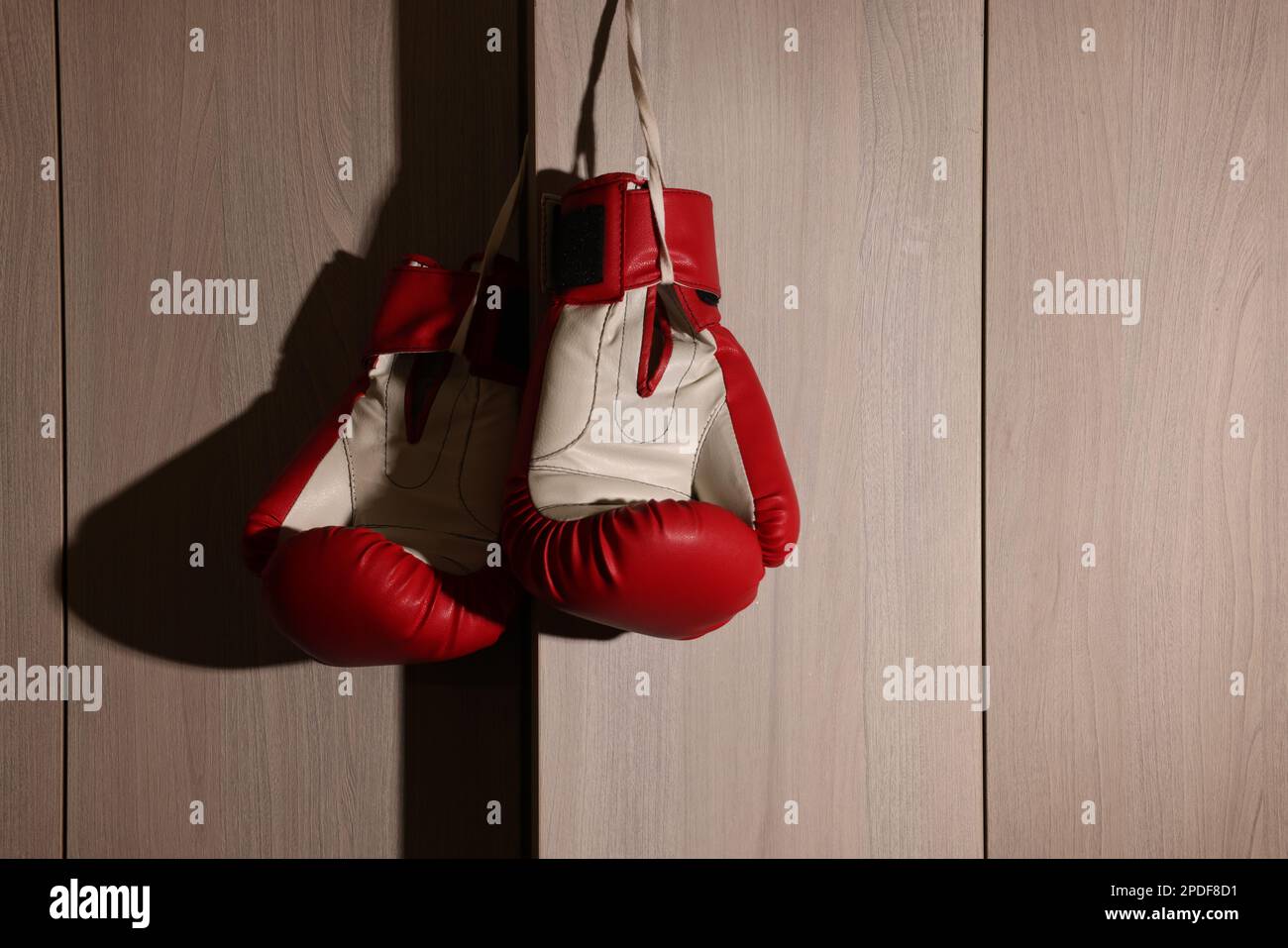 Red boxing gloves hanging on locker door in changing room Stock Photo ...