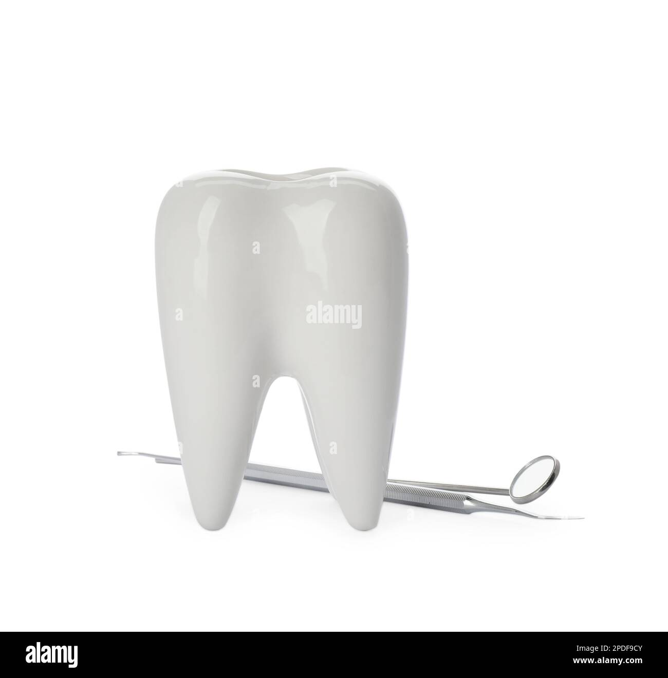 Tooth shaped holder and dentist's tools on white background Stock Photo ...