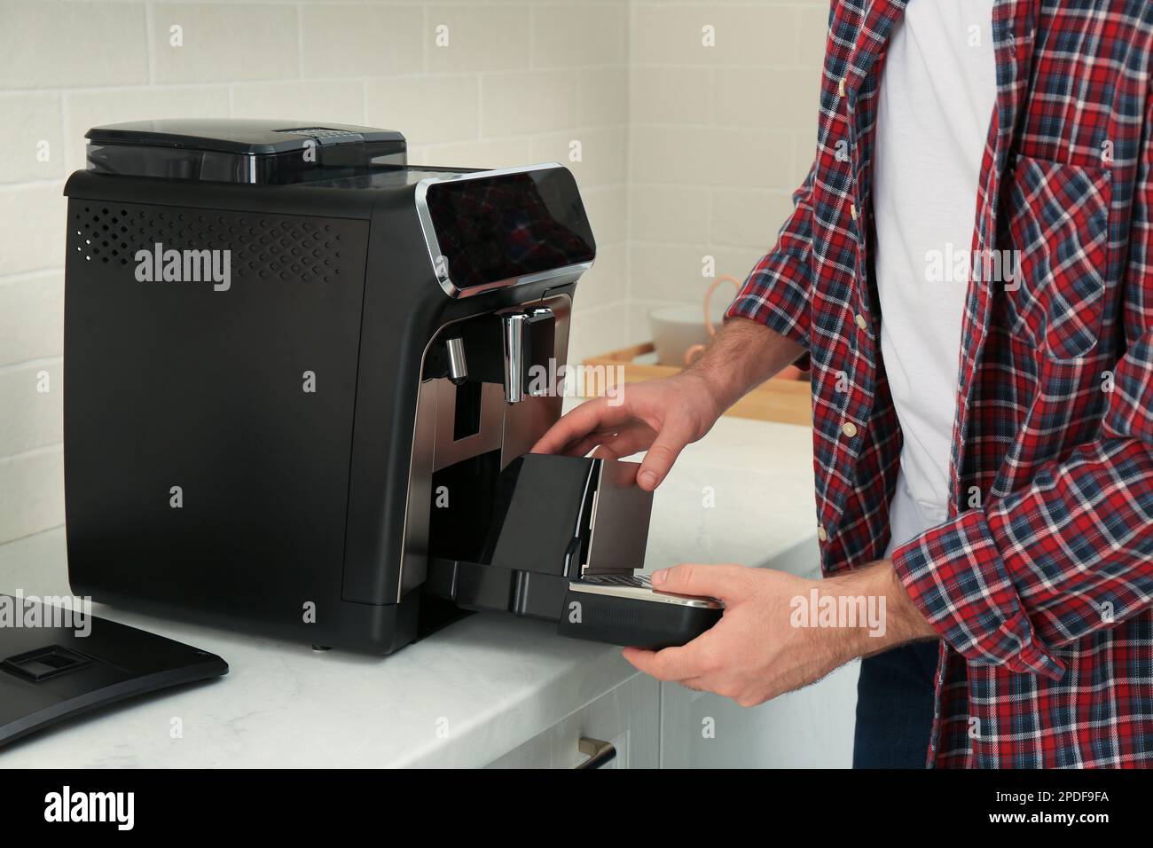Man fixing coffee machine hi-res stock photography and images - Alamy