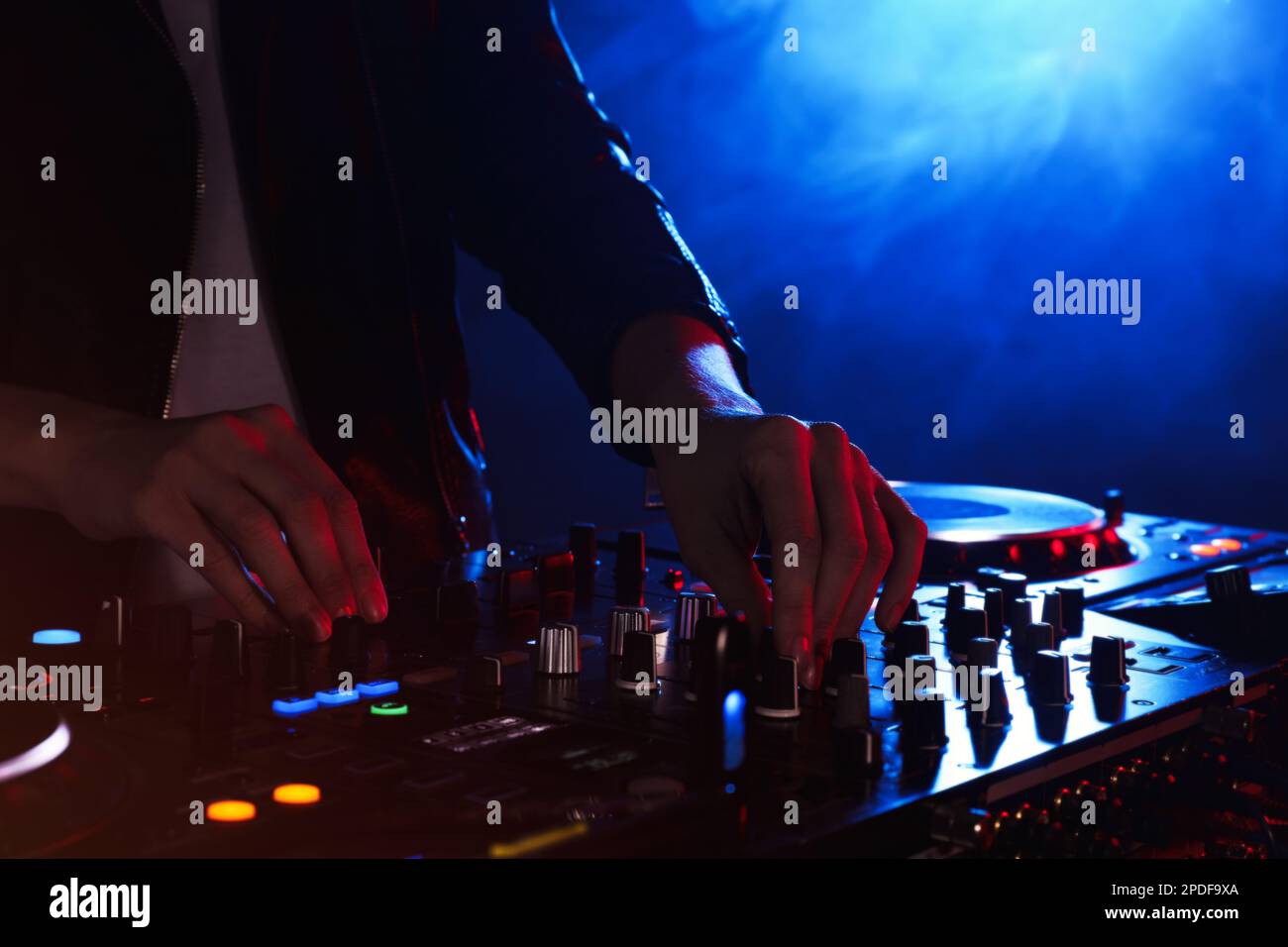 DJ creating music on modern console mixer in night club, closeup Stock ...