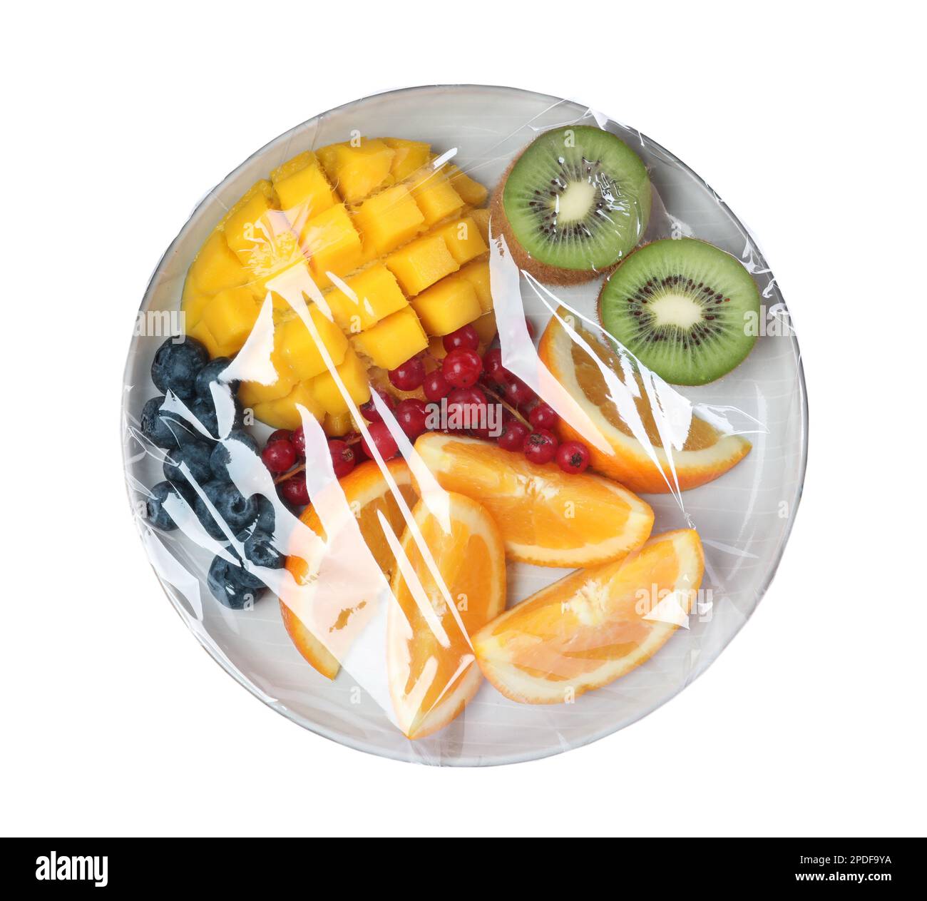 Plate of cut fruits wrapped with transparent plastic stretch film ...