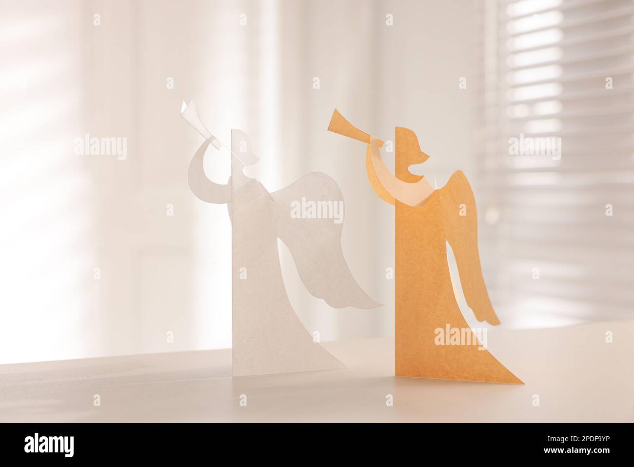 Beautiful angel paper cutouts on white table indoors Stock Photo - Alamy
