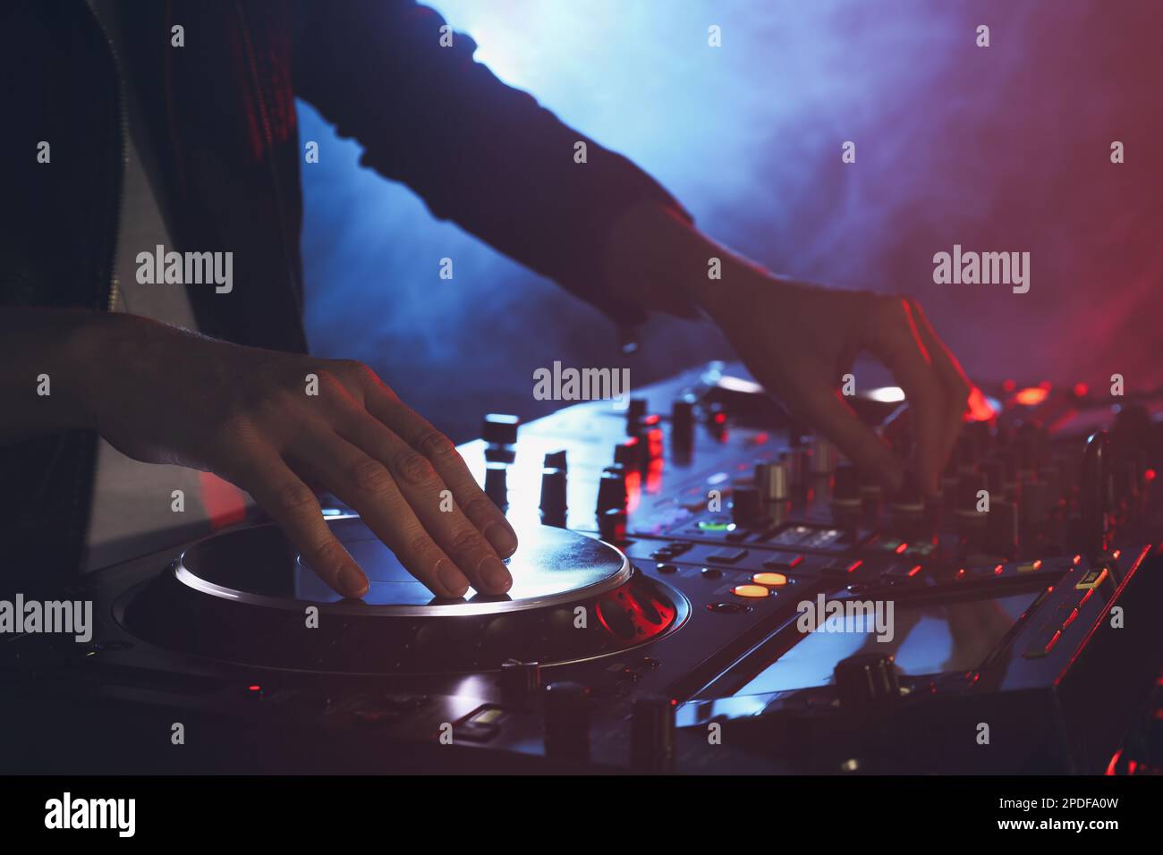 DJ creating music on modern console mixer in night club, closeup Stock ...