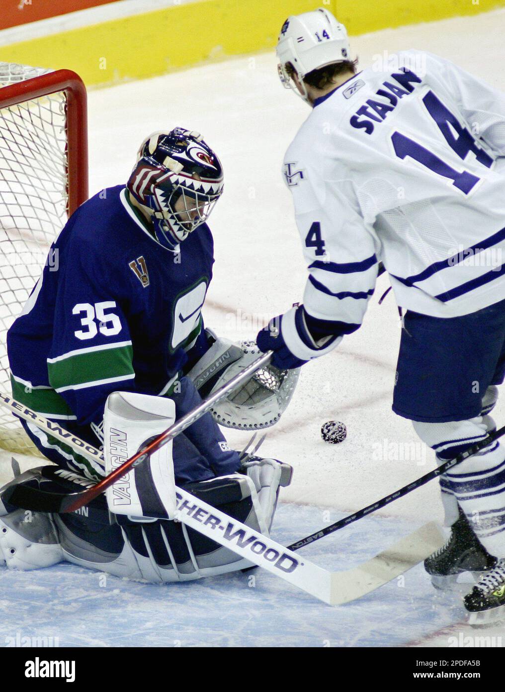 Vancouver Canucks goalie Alex Auld stops Toronto Maple Leafs Matt ...