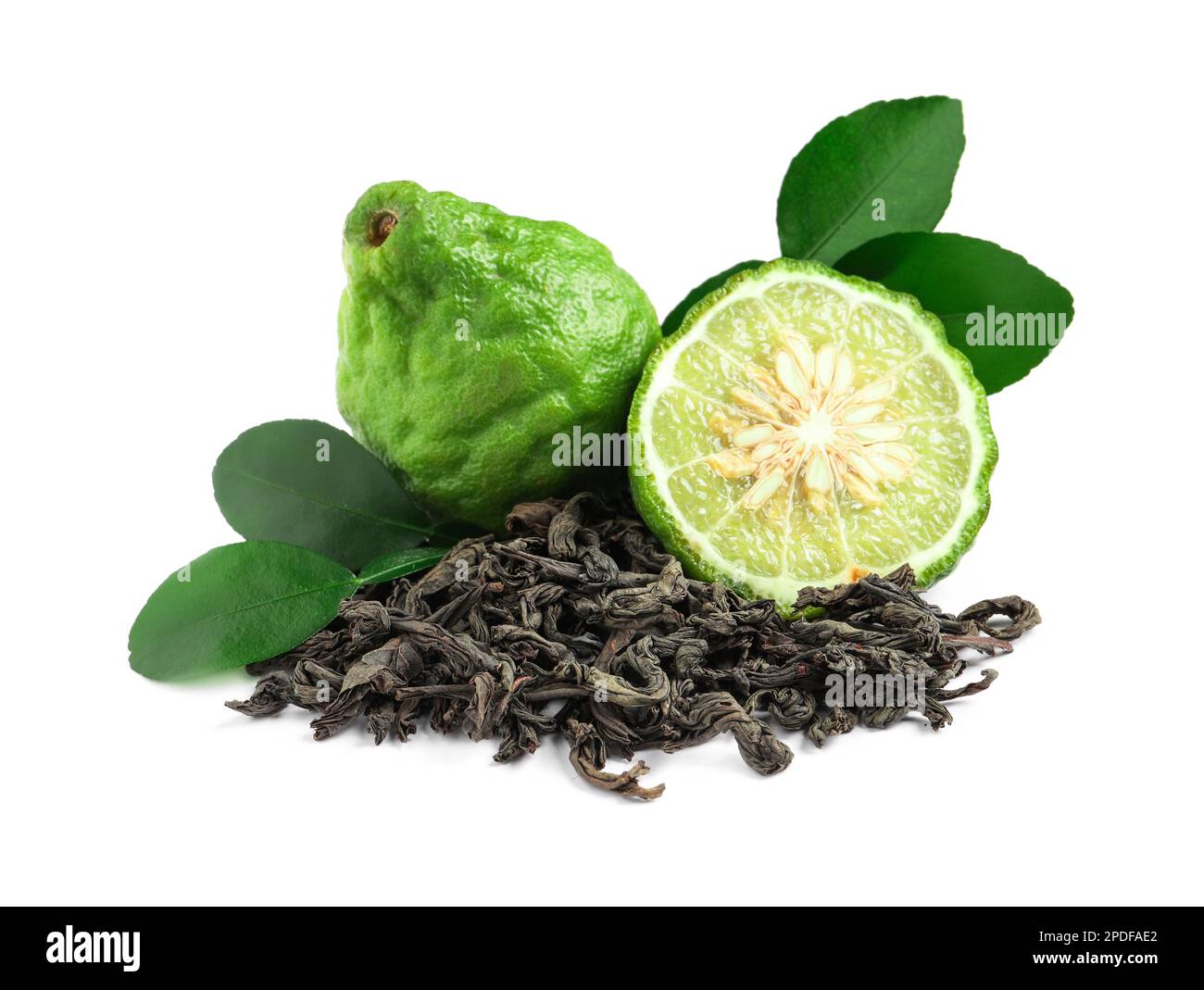 Pile of dry bergamot tea leaves and fresh fruits on white background ...