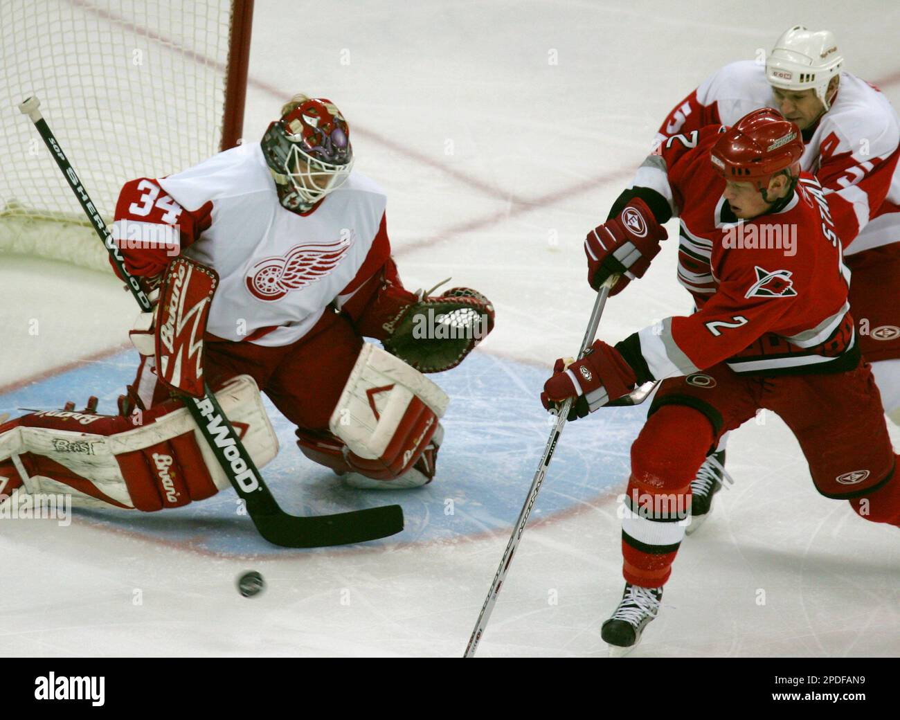 Detroit Red Wings' goalie Manny Legace (34) blocks a shot by Carolina ...