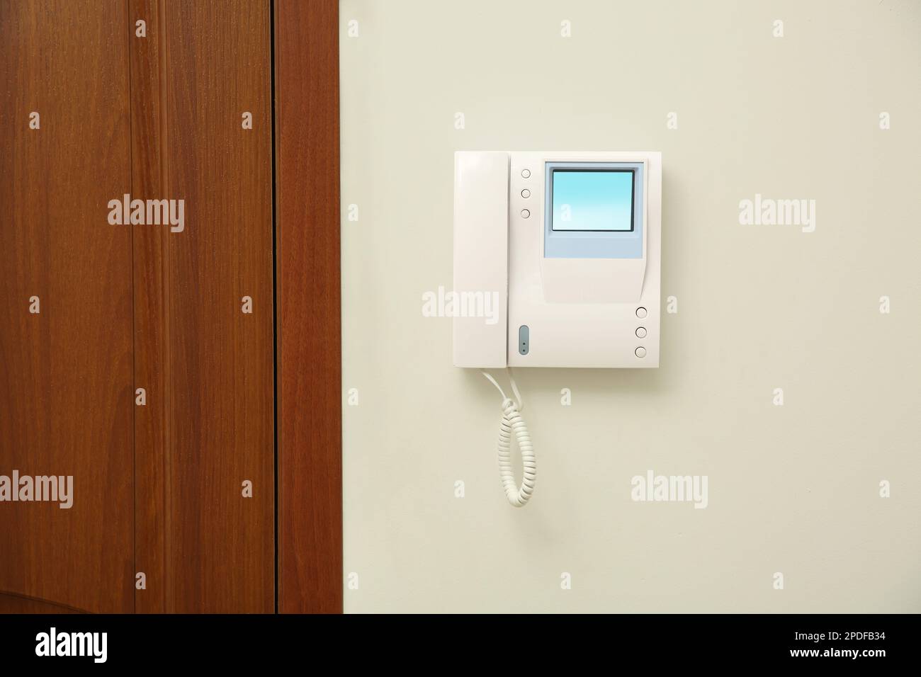 Modern intercom system with handset on white wall indoors Stock Photo ...