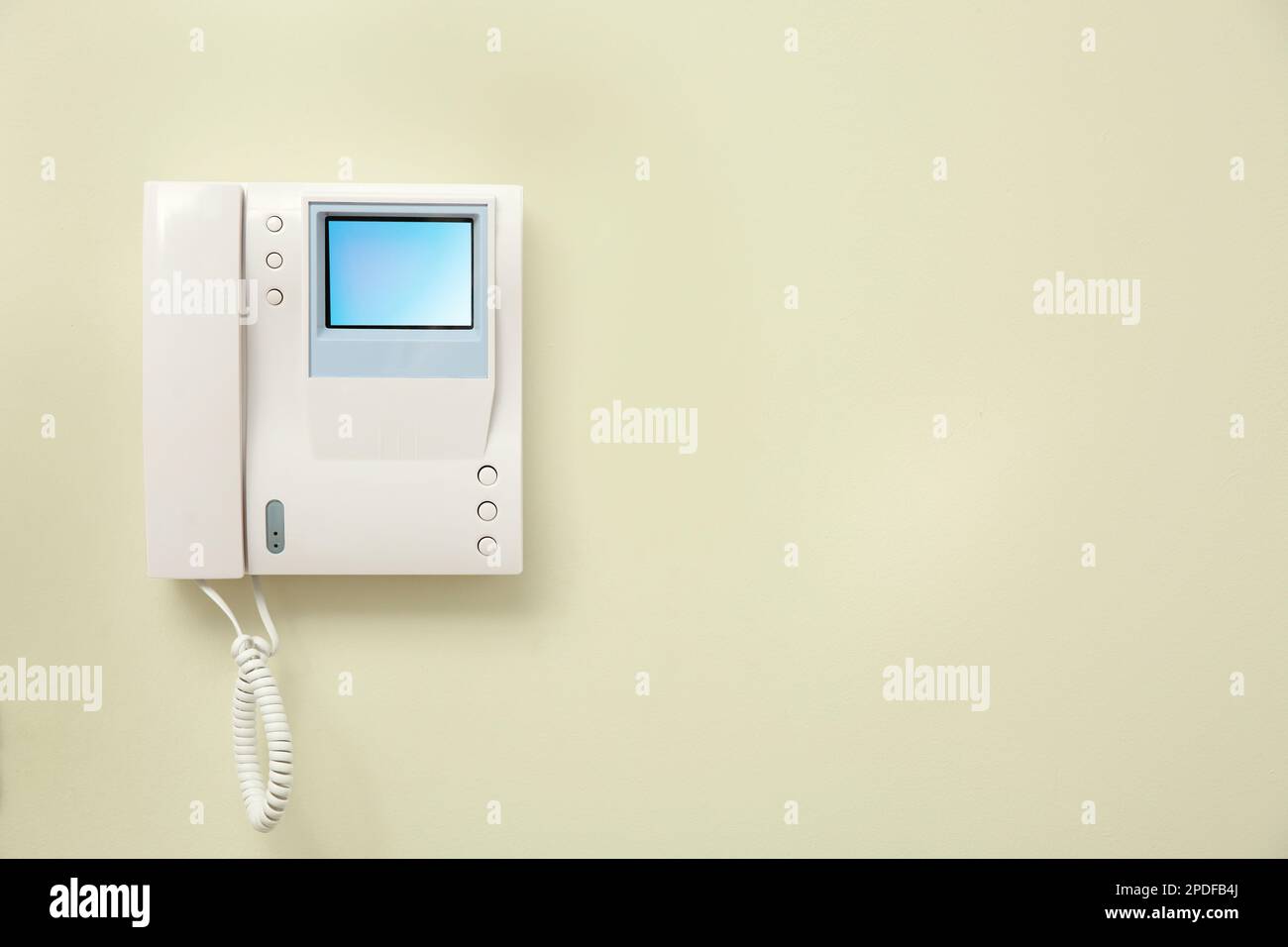 Modern intercom system with handset on light wall, space for text Stock Photo - Alamy