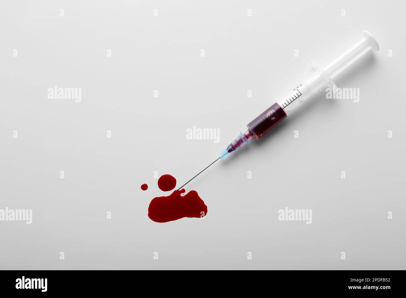 Plastic syringe with blood on white background, top view Stock Photo ...