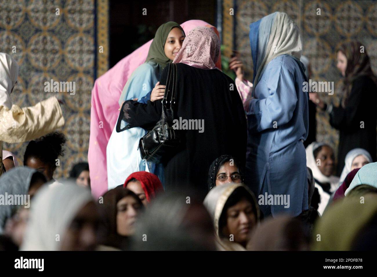 Muslim women greet each other Tuesday, Jan. 10, 2006, at the Zembo ...