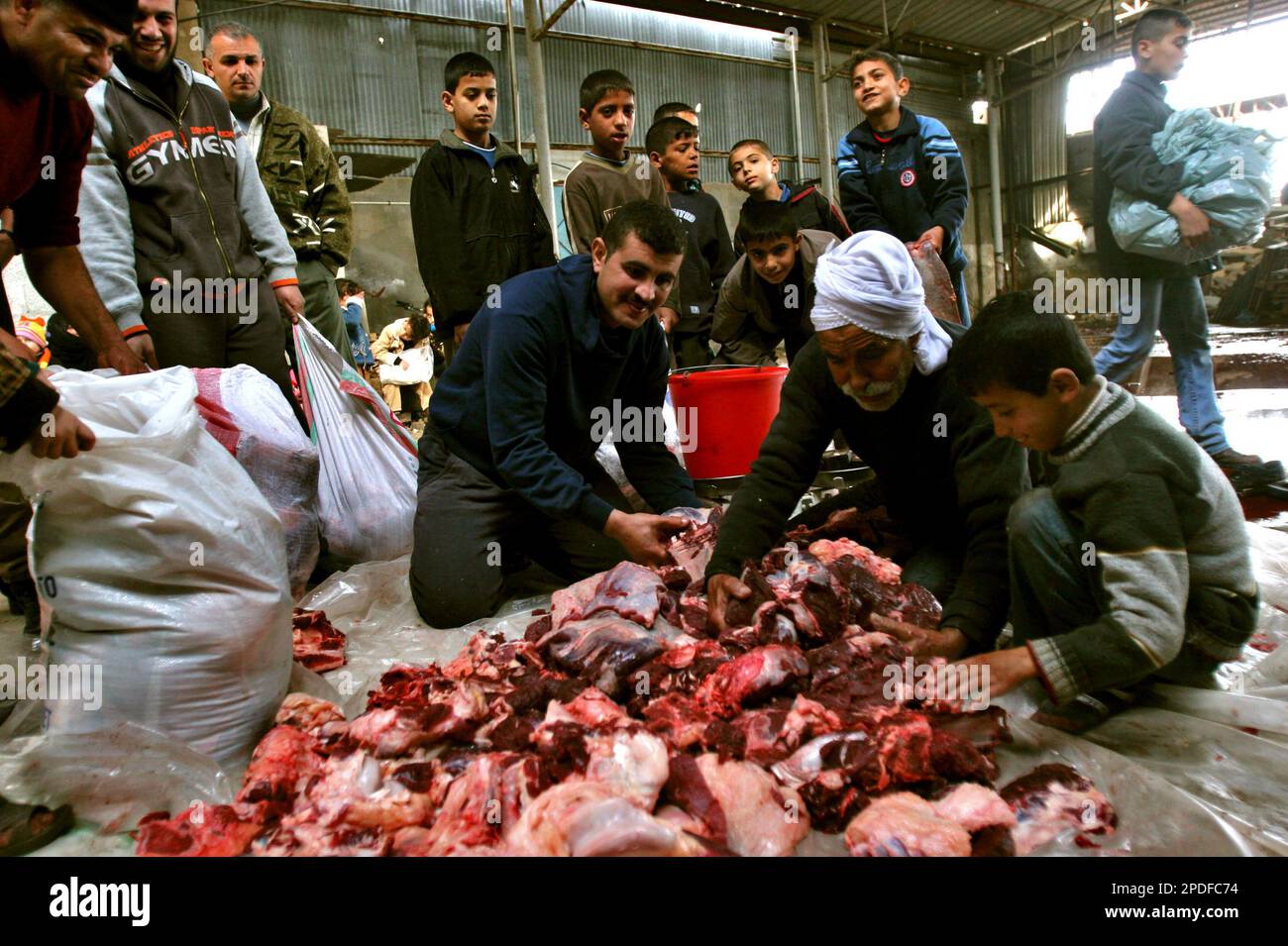 Palestinians select meat parts on the first day of the Muslim feast of ...