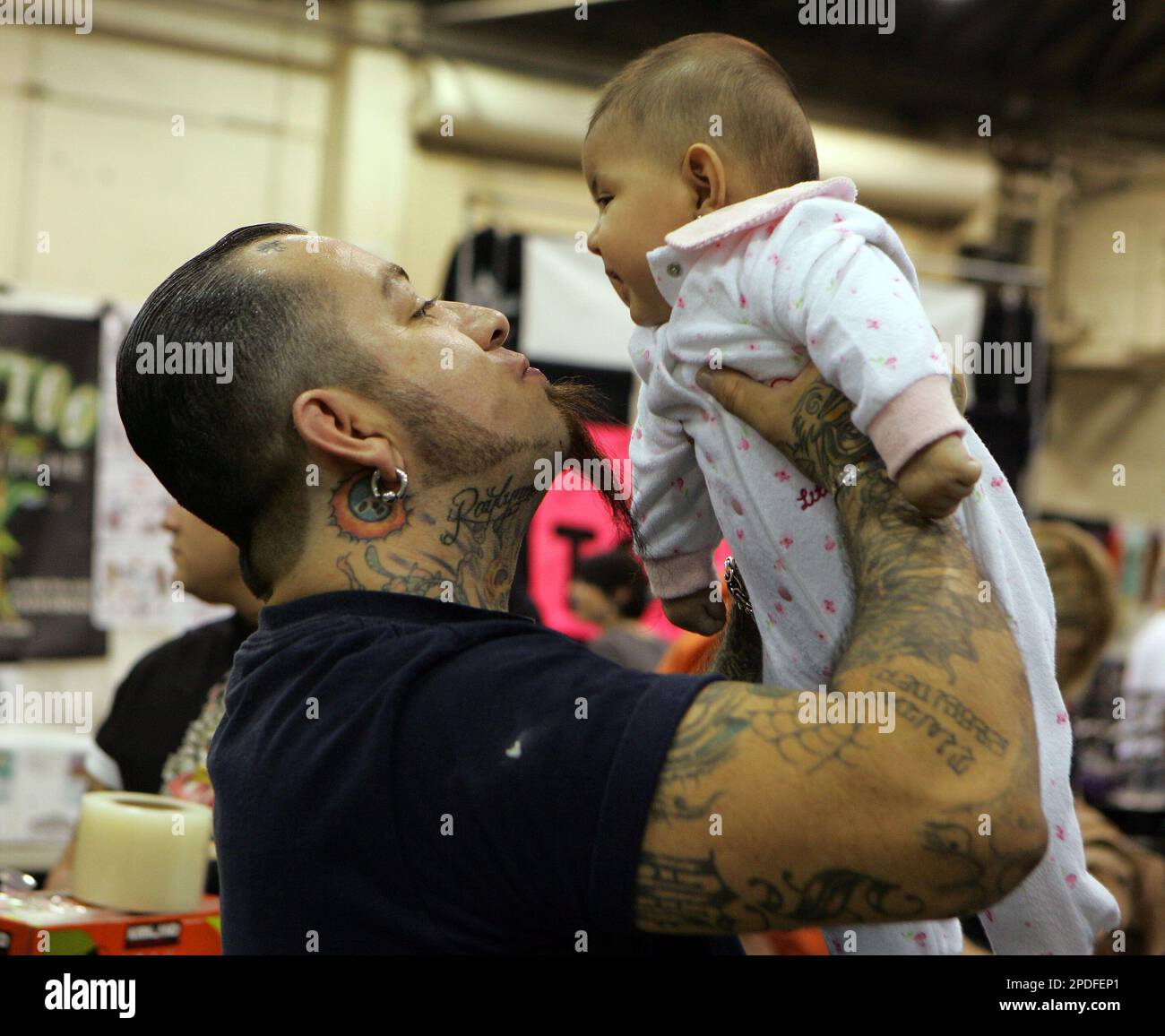 Ray Sanchez of Los Angeles plays with his daughter Raylynne during the ...
